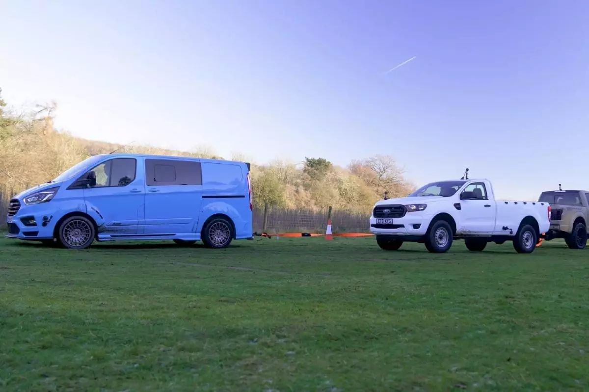 The Ford F-150 Raptor plays tug of war against two of its brothers